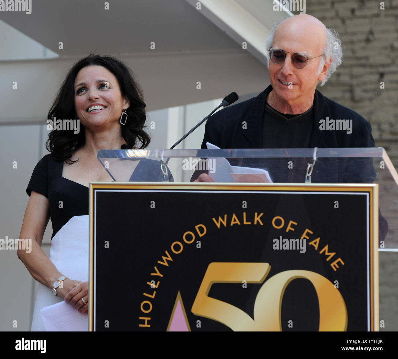 Actress Julia Louis-Dreyfus (L) listens to actor and writer Larry David ...