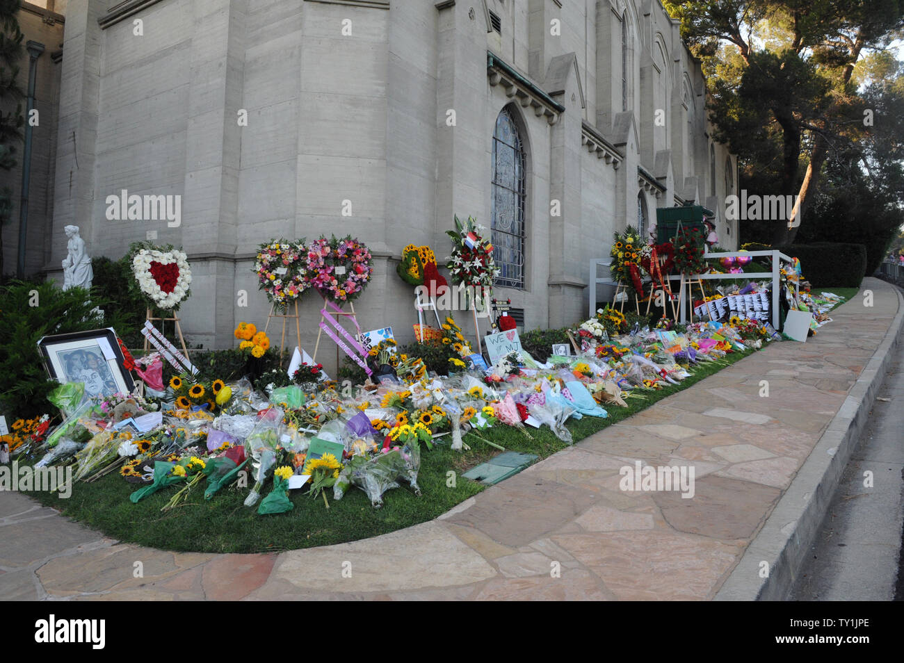A makeshift shrine sits quitely outside the ornate mausoleum where ...