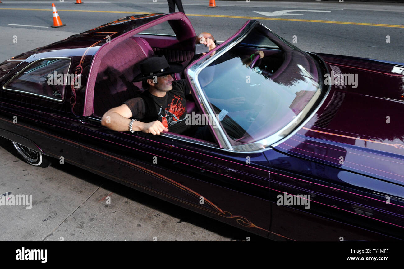 Director Robert Rodriguez arrives in a lowrider car at the premiere of ...