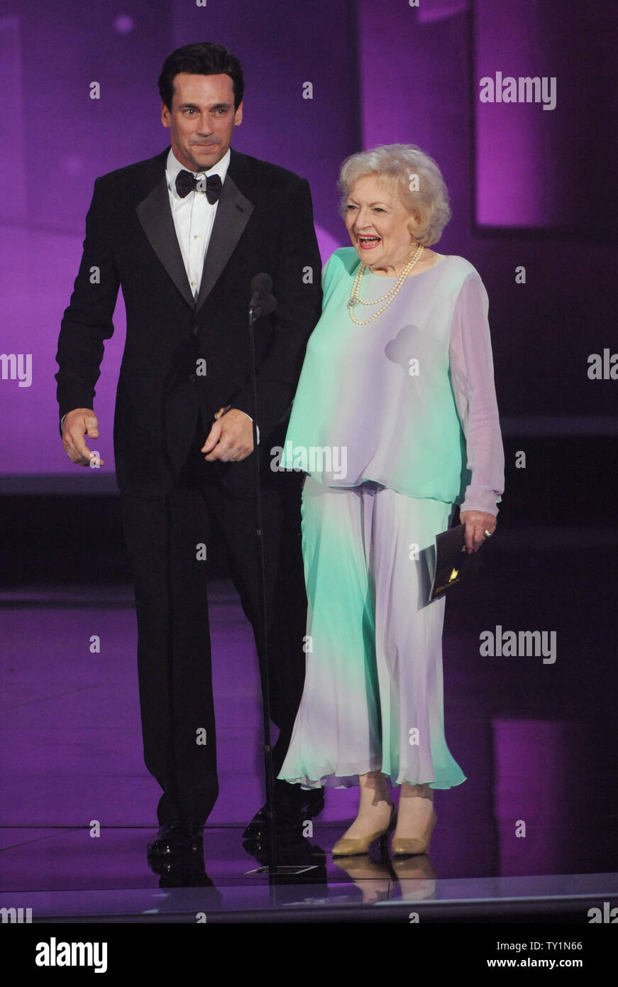 Actor Jon Hamm (L) and actress Betty White announce Eric Stonestreet as ...