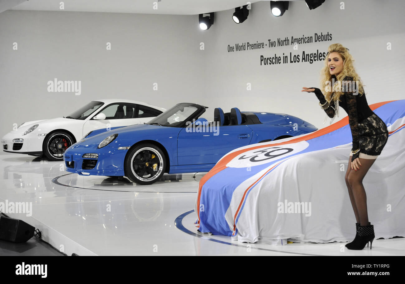 Models help unveil new car models during the Porsche presentation at ...