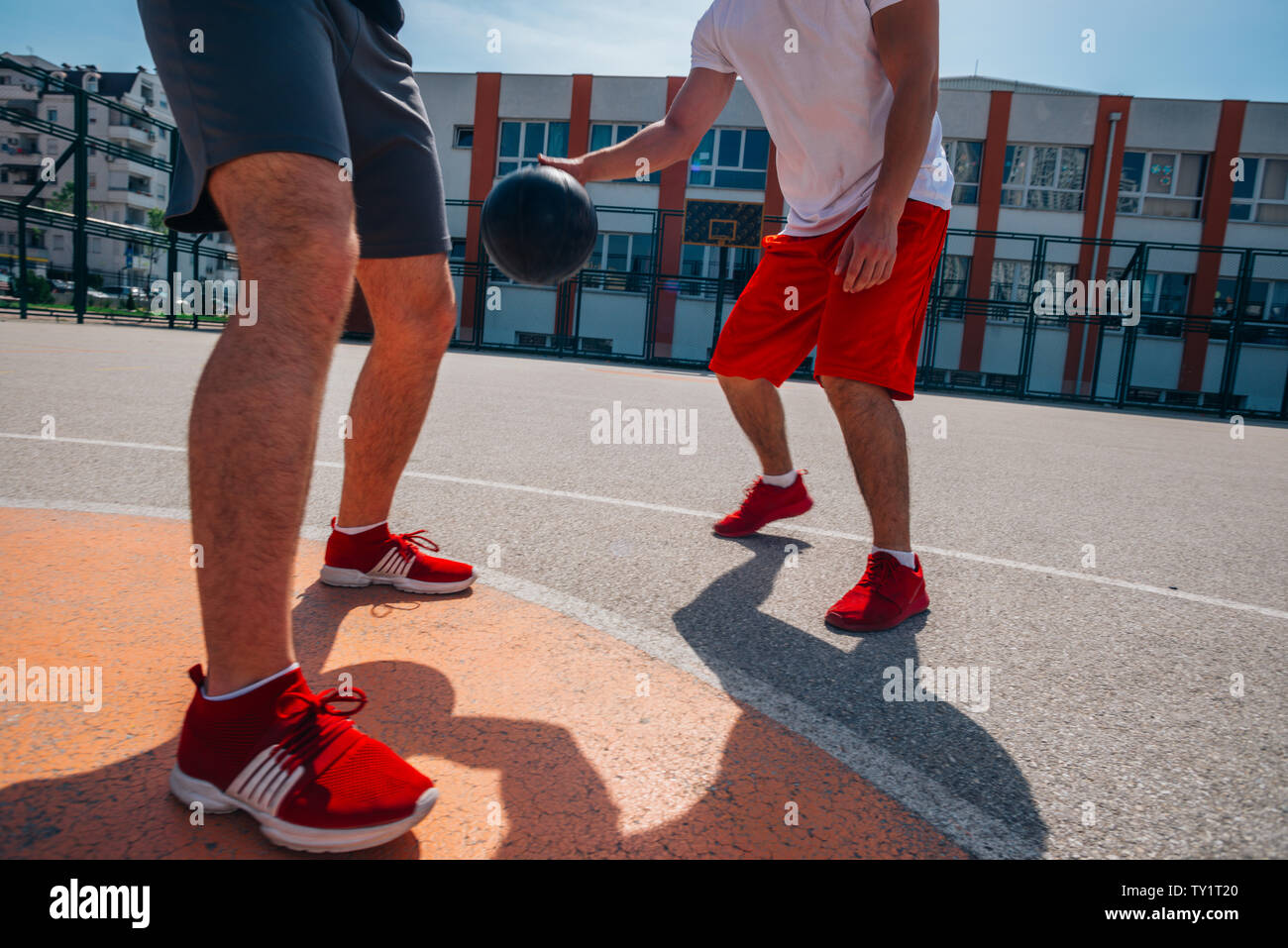 Two street basketball players playing one on one lot of close up action ...