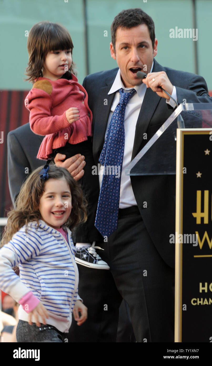 Actor Adam Sandler holds his daughter Sunny while daughter Sadie reacts ...