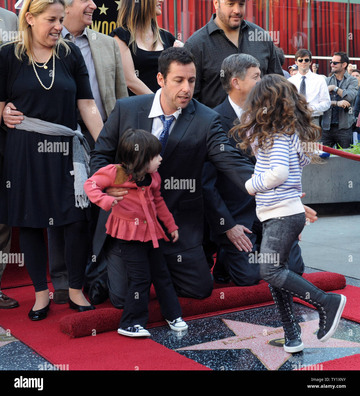 Actor Adam Sandler rounds up his daughters Sunny (L) and Sadie during ...