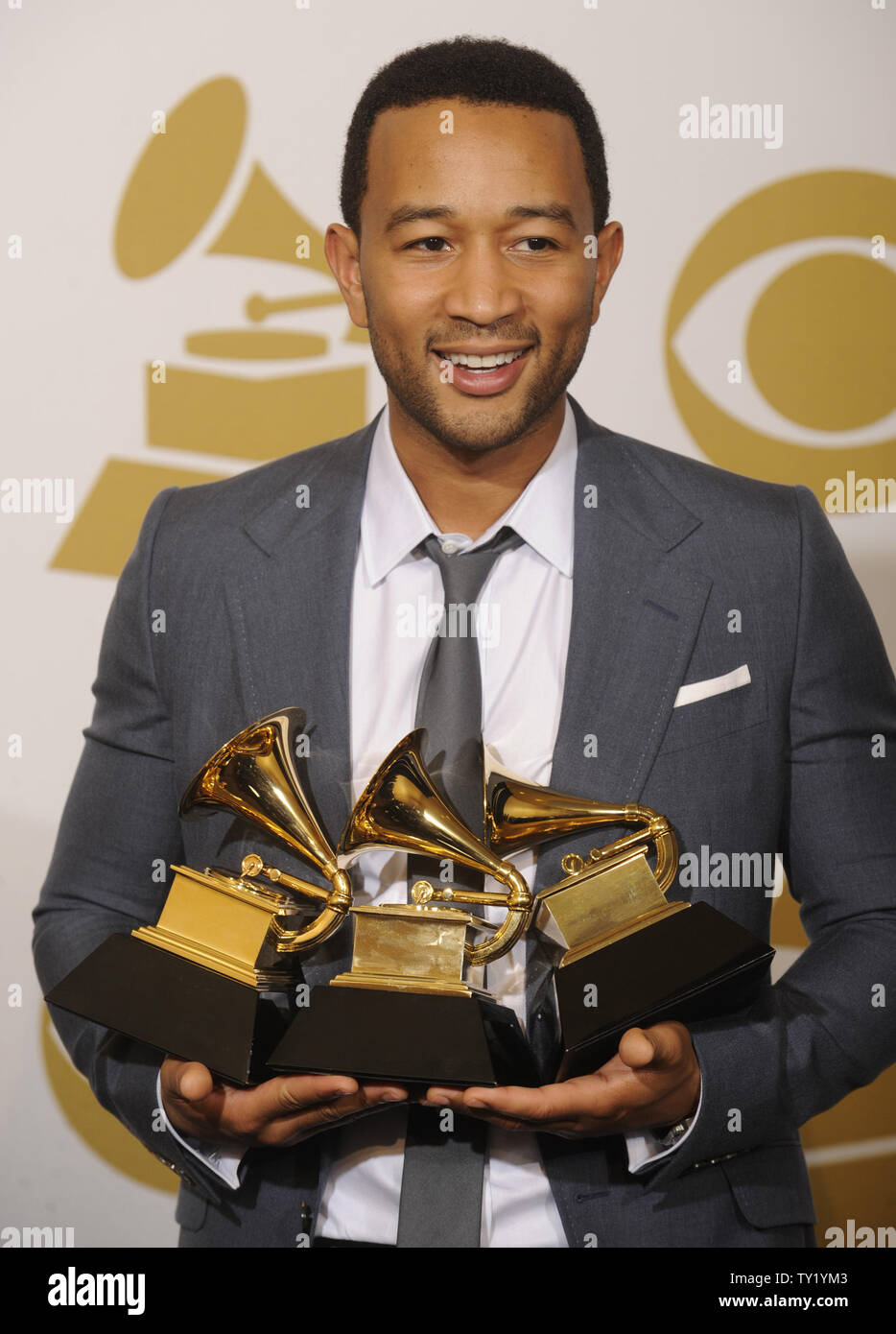 John Legend appears backstage with the three Grammy Awards he won at ...