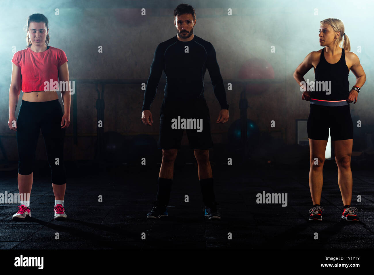 Team of young athletes standing in fitness center Stock Photo - Alamy