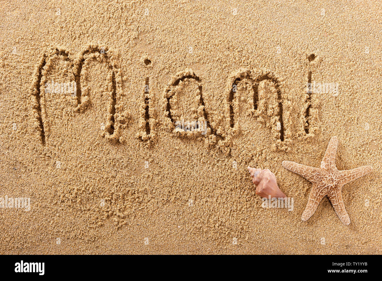 Miami beach word sign message written in sand Stock Photo - Alamy