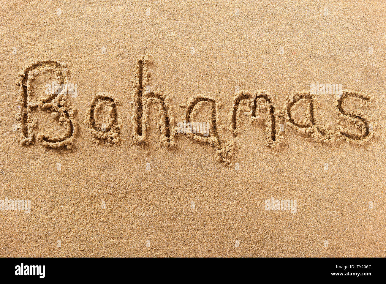 Bahamas beach word message written in sand Stock Photo - Alamy