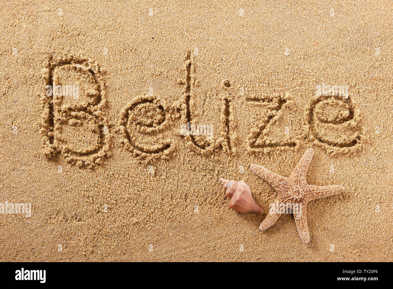 Belize beach word sign written in sand Stock Photo - Alamy