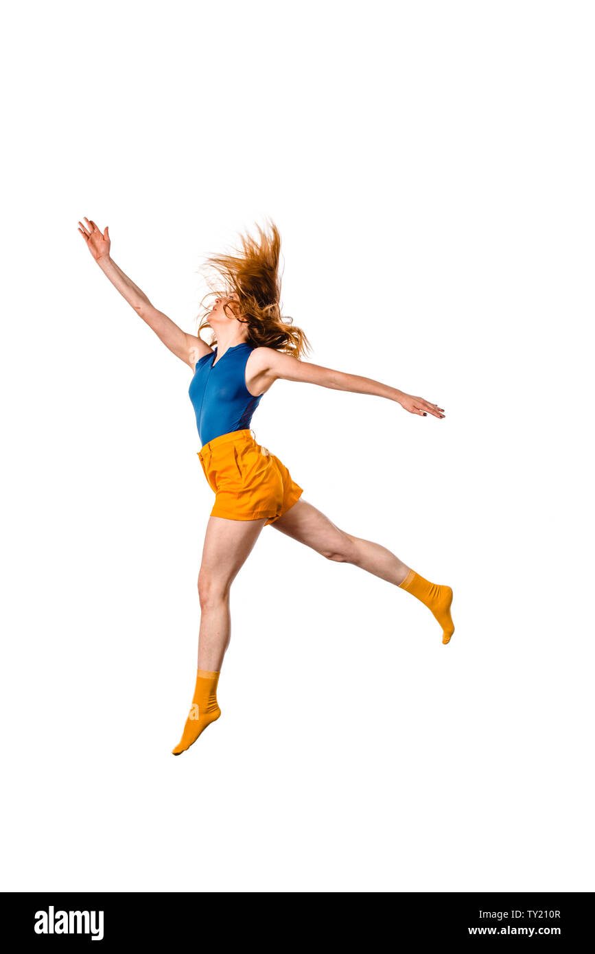 Female dancer jumping in the air wearing fashionable clothes Stock ...
