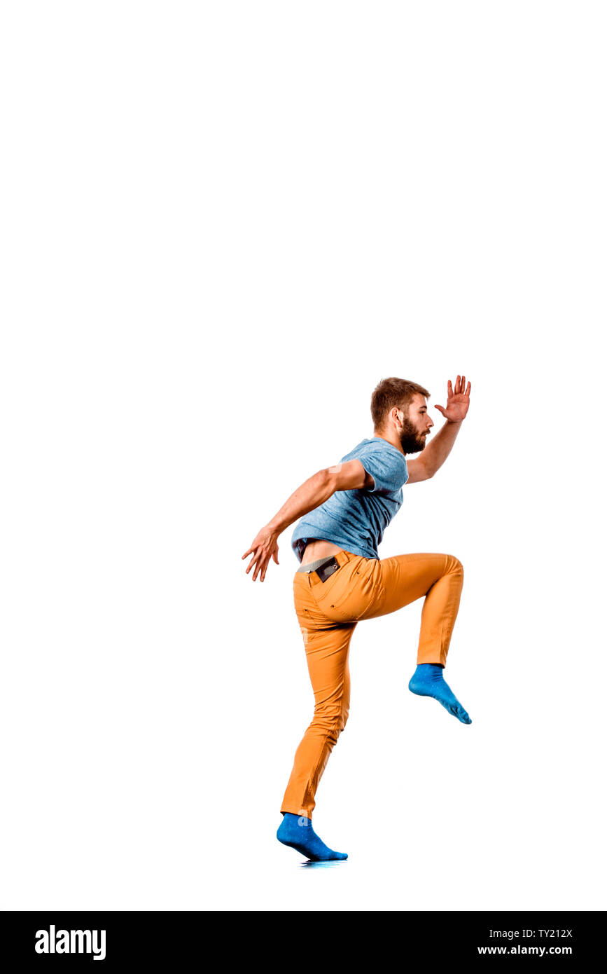 Happy young man dancing against plain white background Stock Photo - Alamy