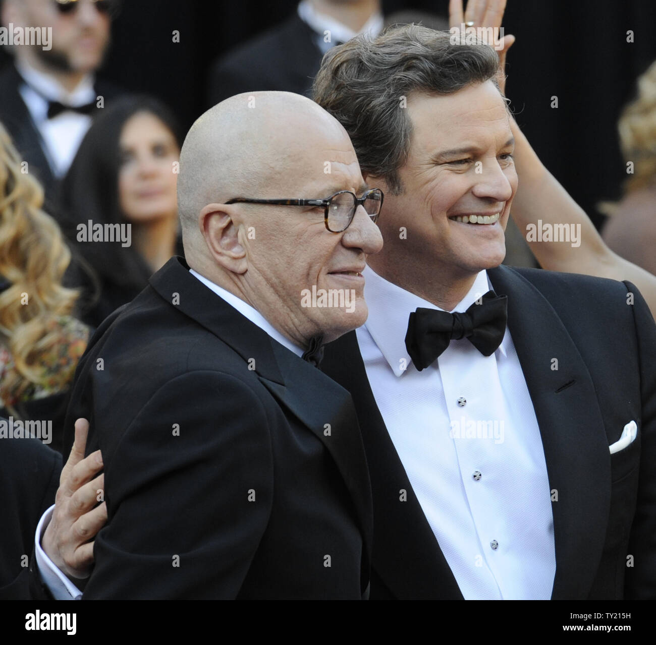 Jeremy Rush and Colin Firth arrive on the red carpet for the 83rd ...