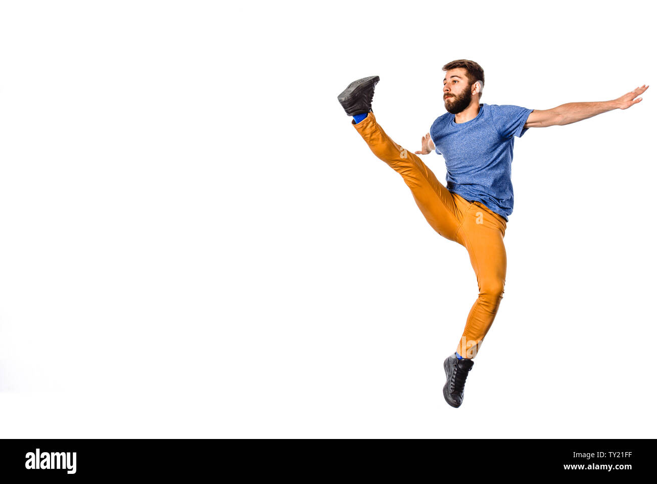 Happy young man dancing against plain white background Stock Photo - Alamy