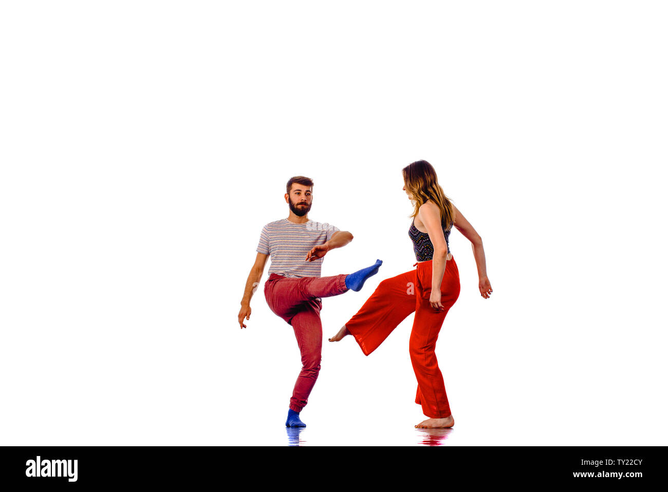 Romantic couple dancing together in studio, isolated on white ...