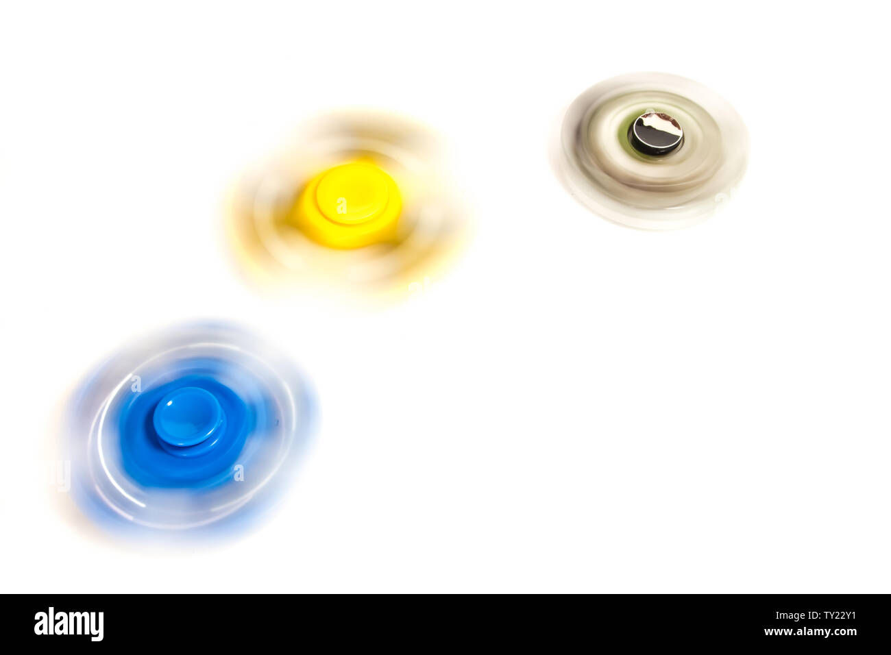 fidget hand spinner spinning on white background Stock Photo - Alamy