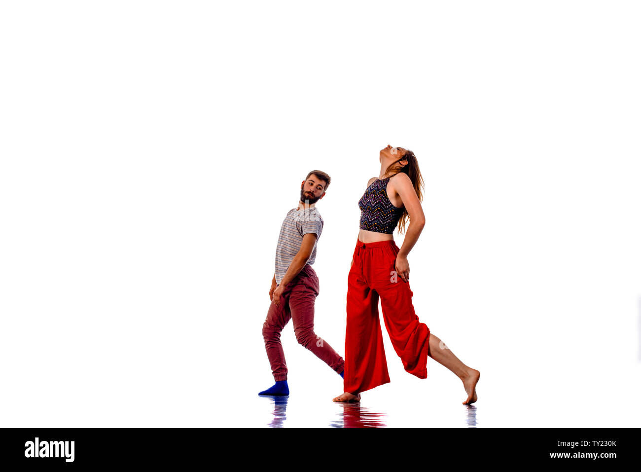 Romantic couple dancing together in studio, isolated on white ...