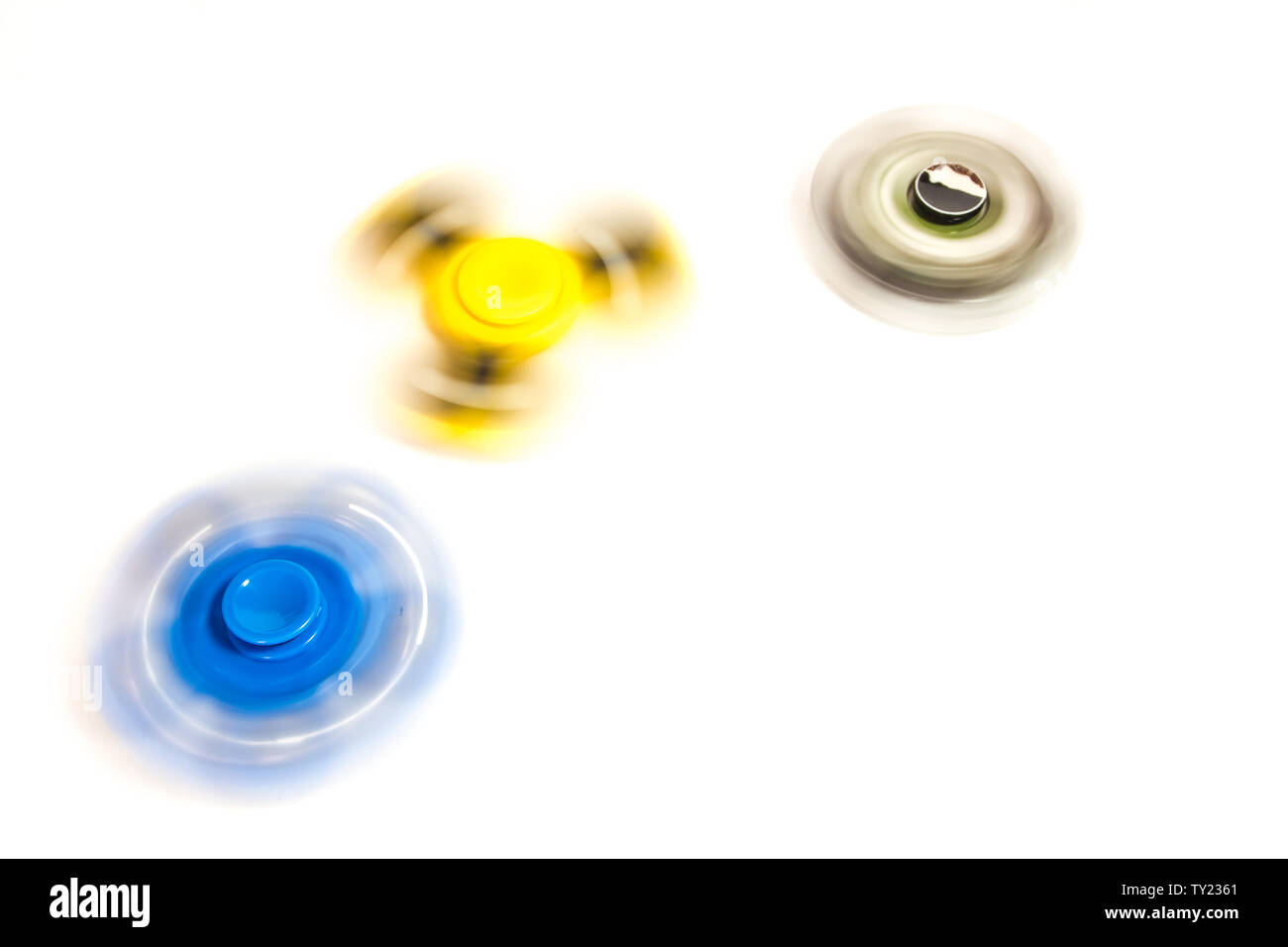 fidget hand spinner spinning on white background Stock Photo - Alamy