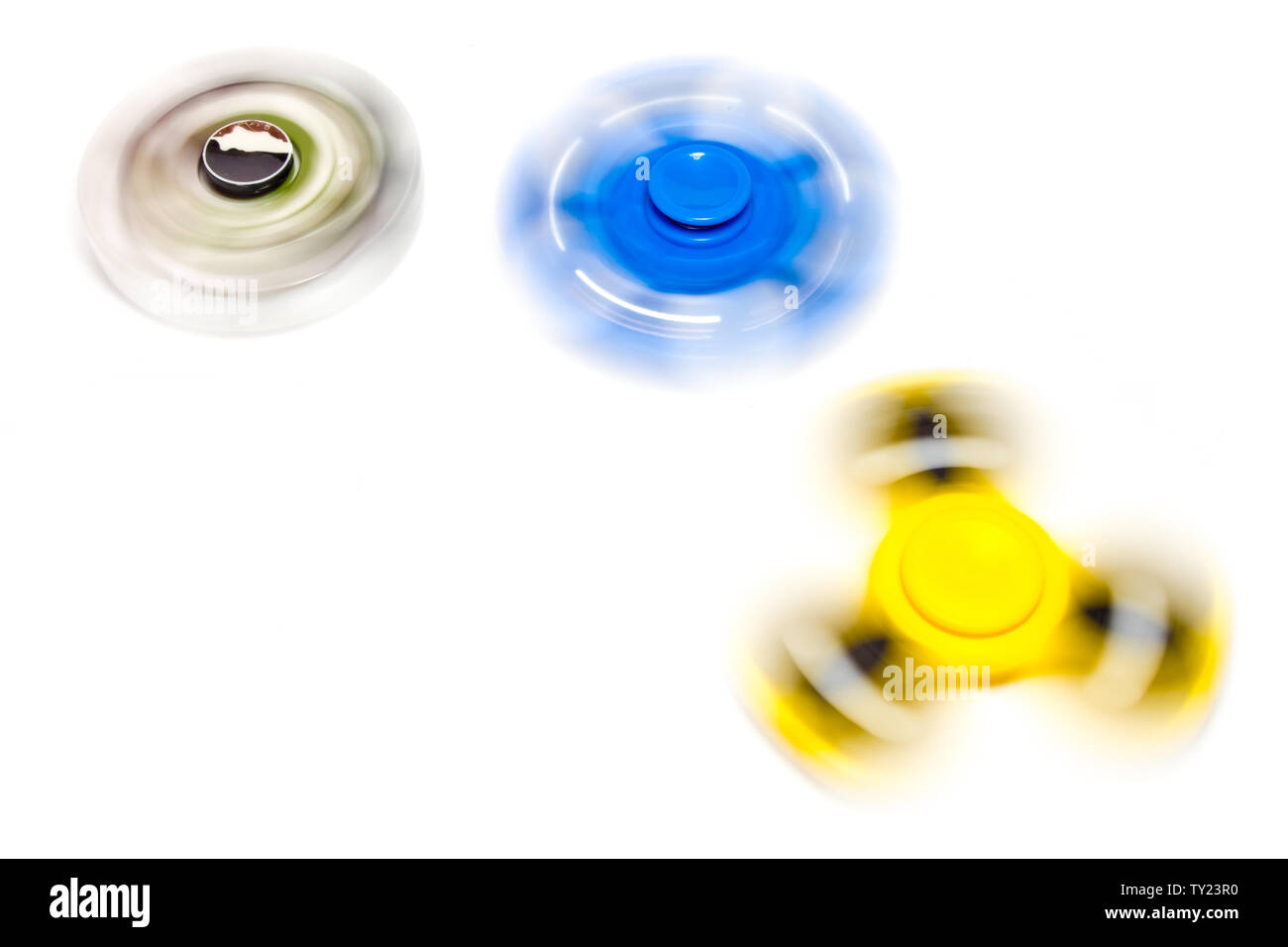 fidget hand spinner spinning on white background Stock Photo - Alamy