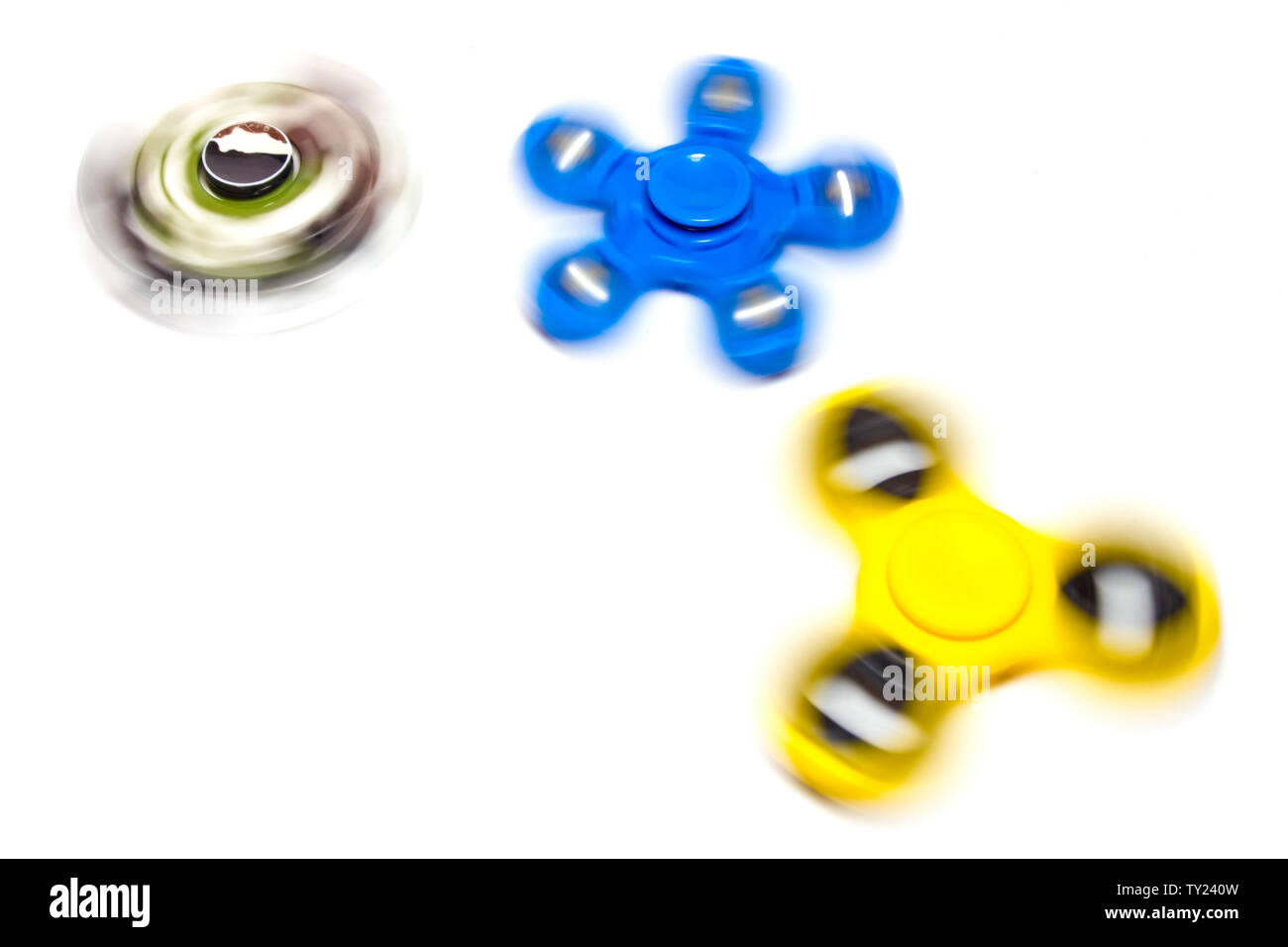 fidget hand spinner spinning on white background Stock Photo - Alamy