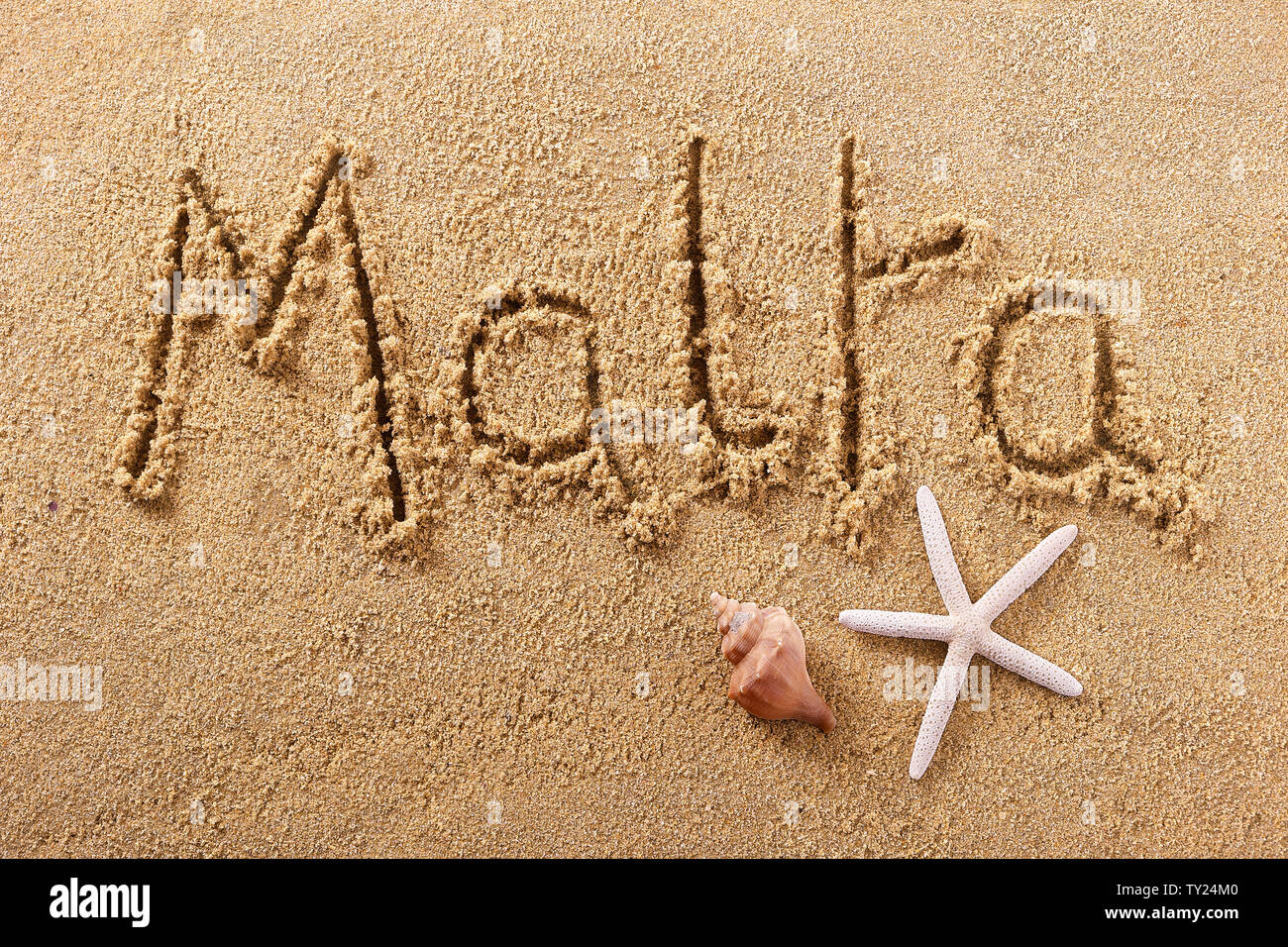Malta beach word written in sand travel sign concept Stock Photo - Alamy