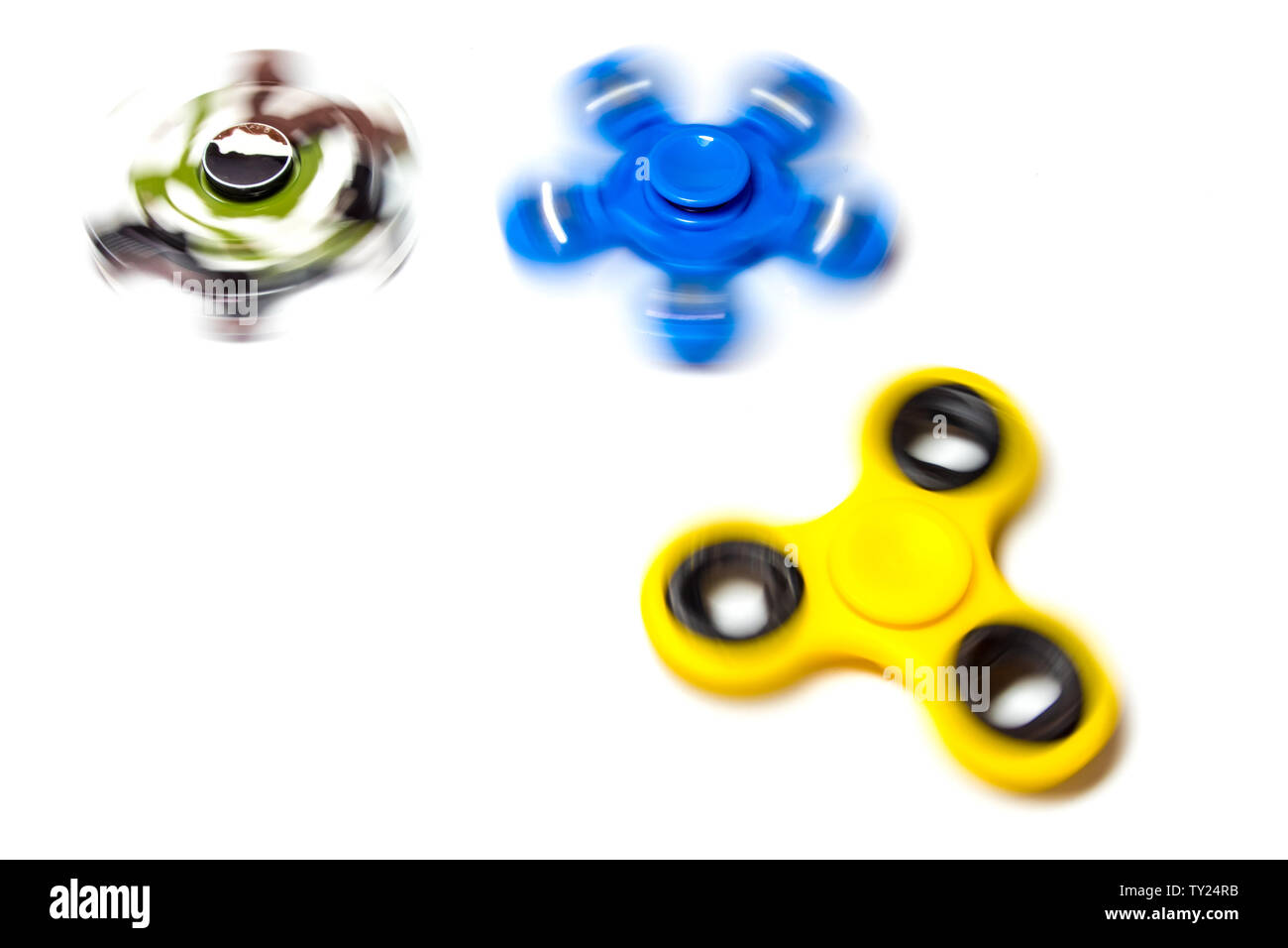 fidget hand spinner spinning on white background Stock Photo - Alamy