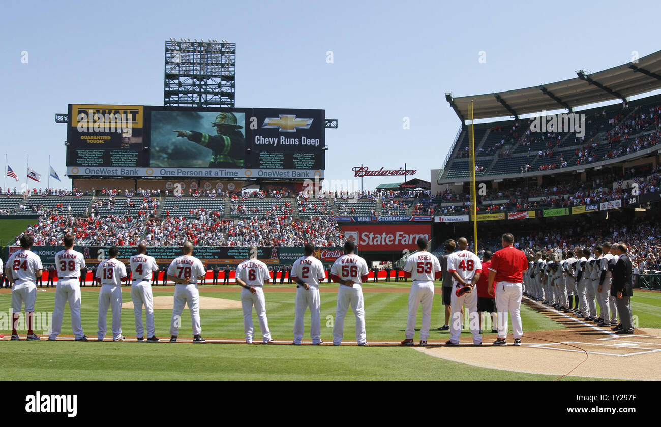 Los Angeles Angels and New York Yankees stand on the field during the ...