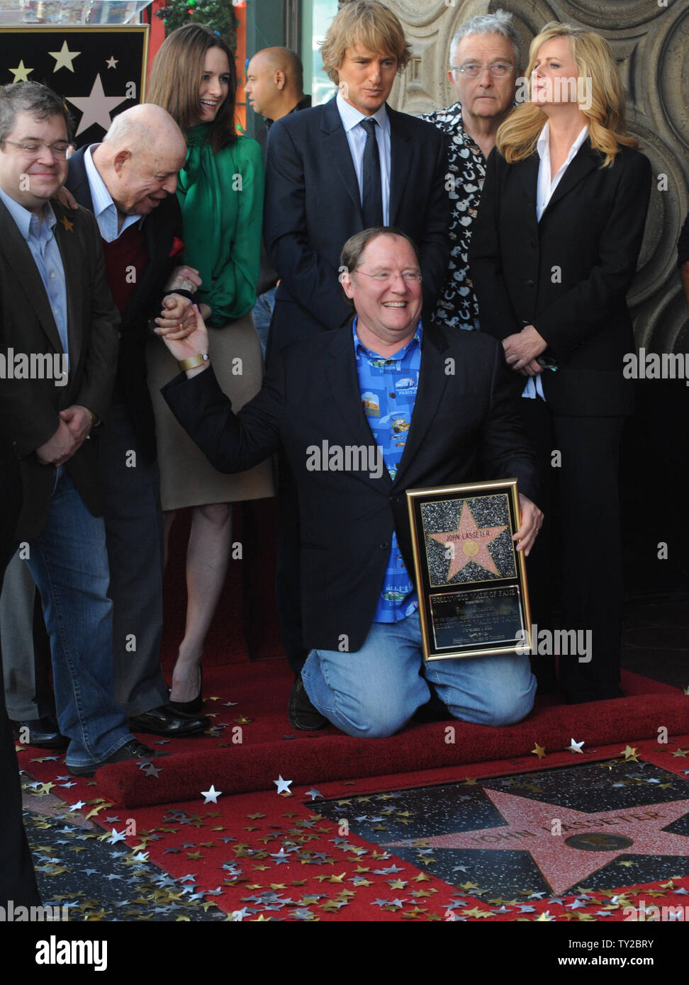 Director John Lasseter holds the hand of comedianr Don Rickles during ...