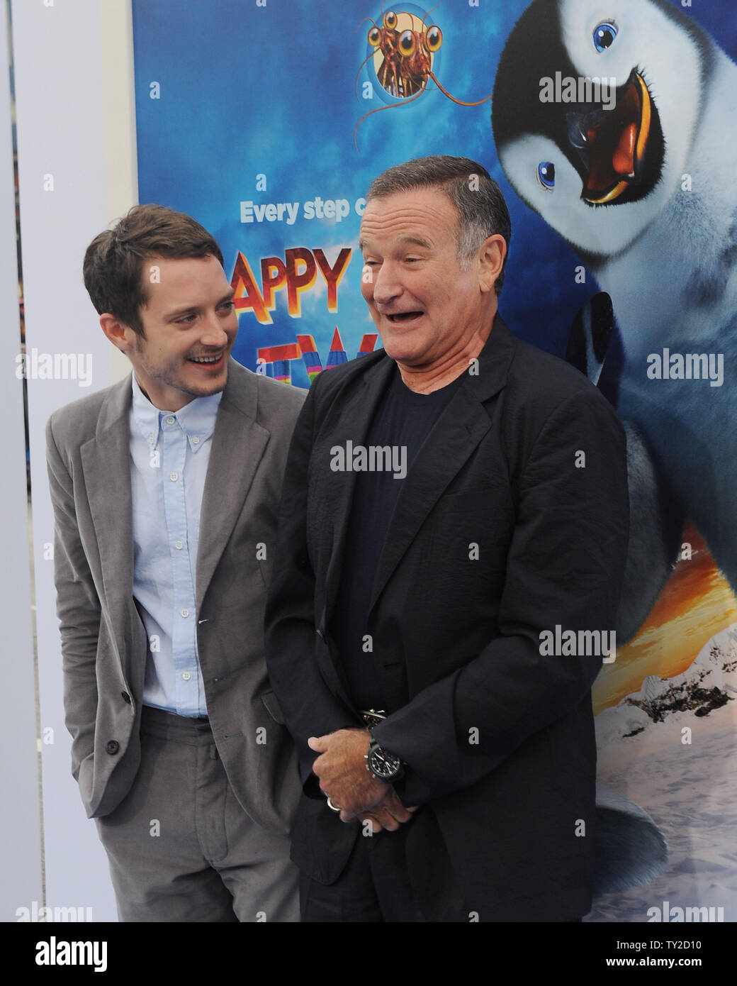 Elijah Wood (L) and Robin Williams, cast members in the animated motion ...