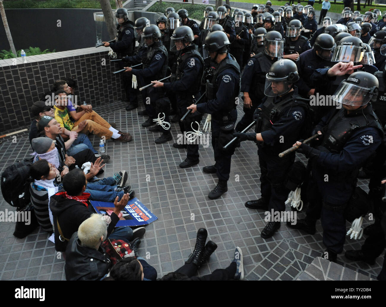 A large contingent of police in riot gear face off with 10 protesters ...