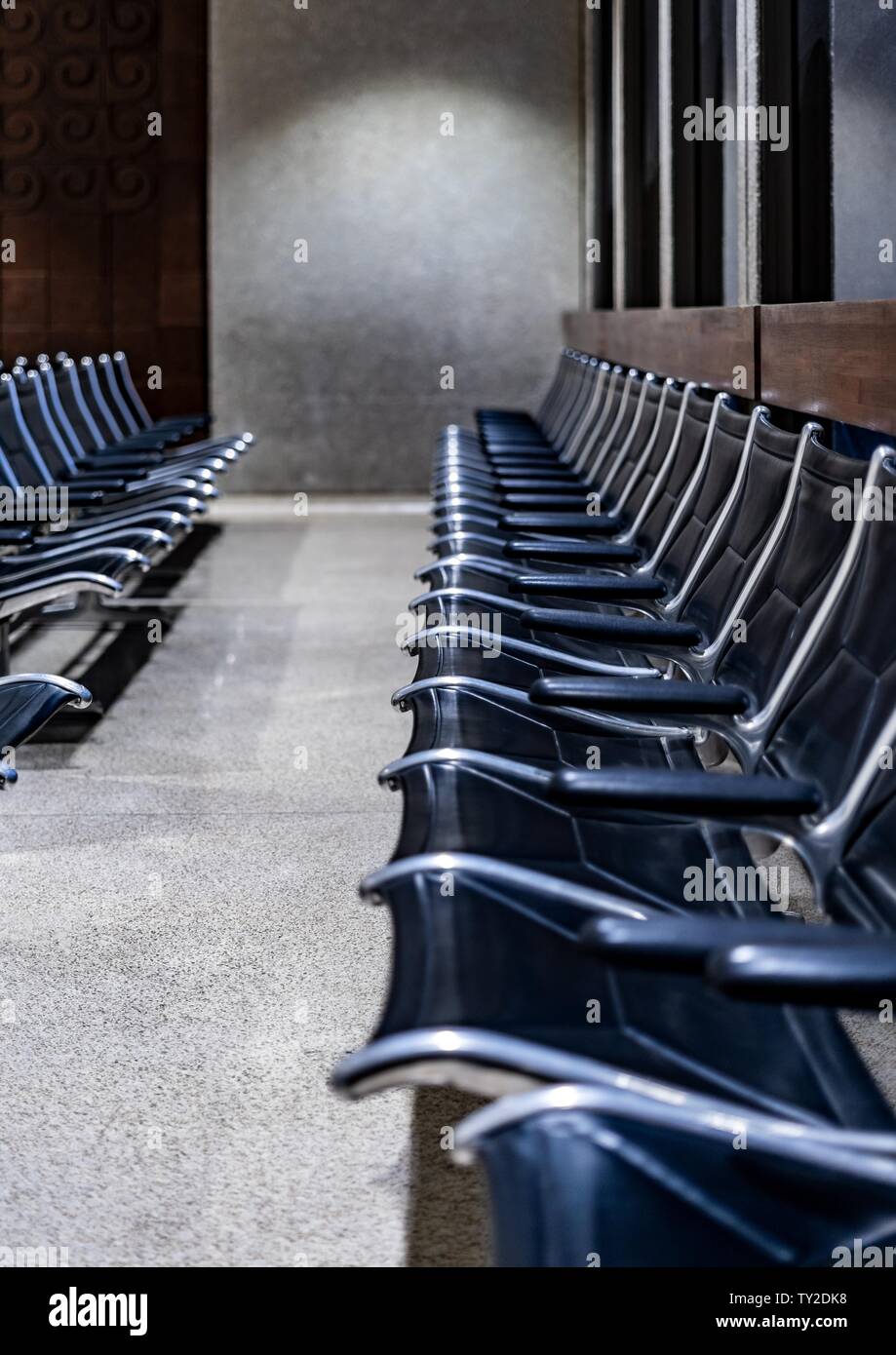 Connected metal chairs at an empty station Stock Photo - Alamy