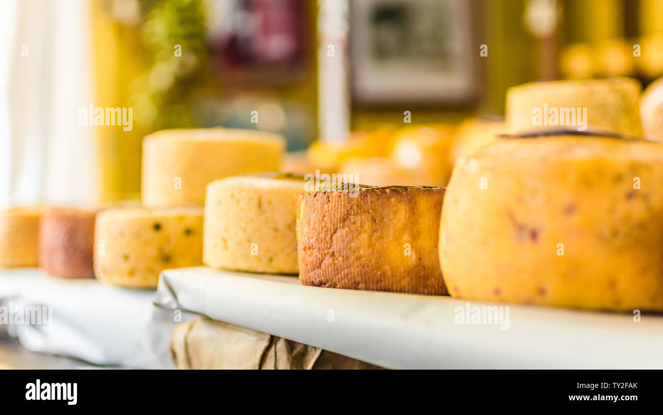 Selection of traditional Italian cheeses on a display, selective focus ...