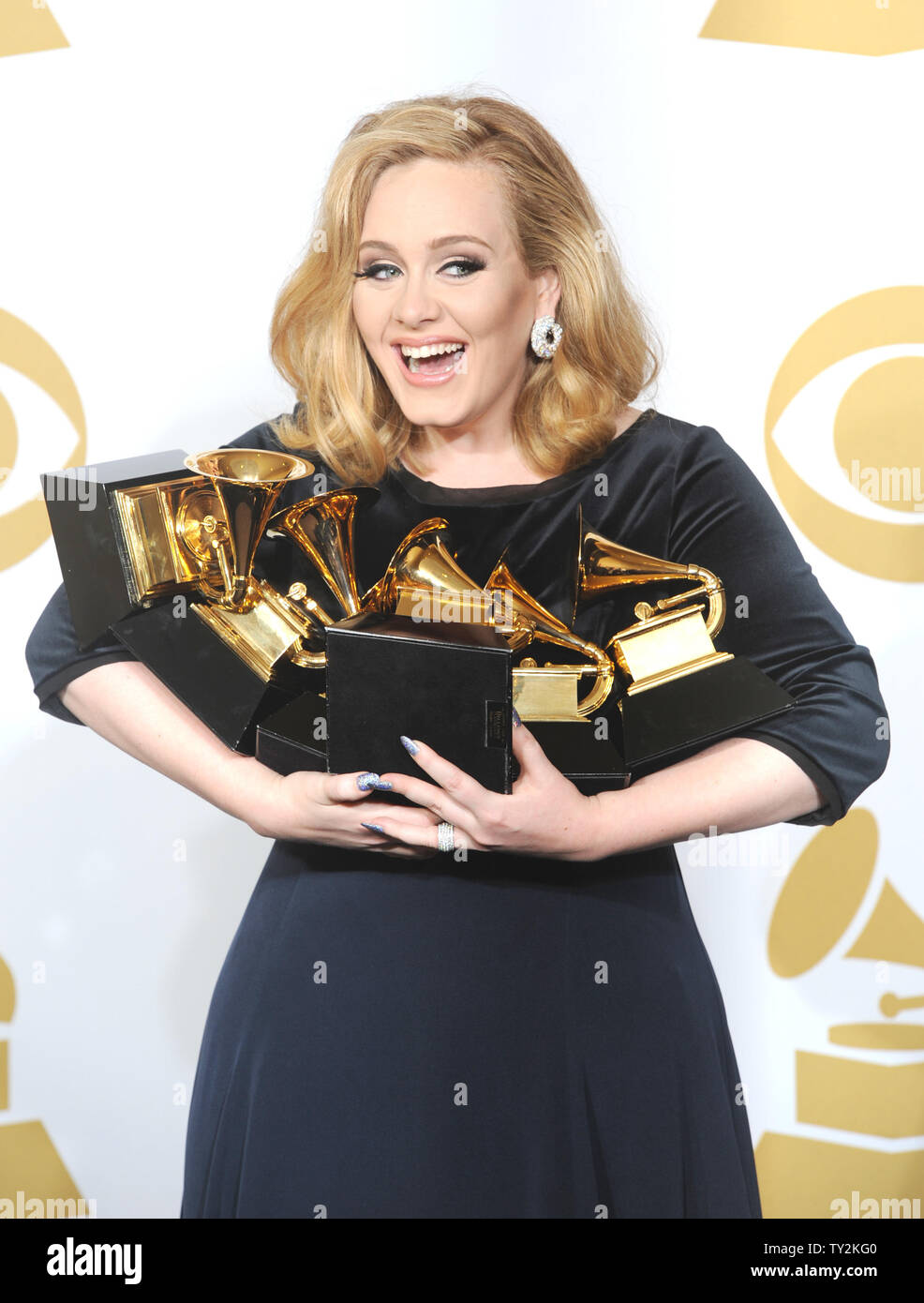 Adele cradles the six awards she won at the 54th annual Grammy Awards ...