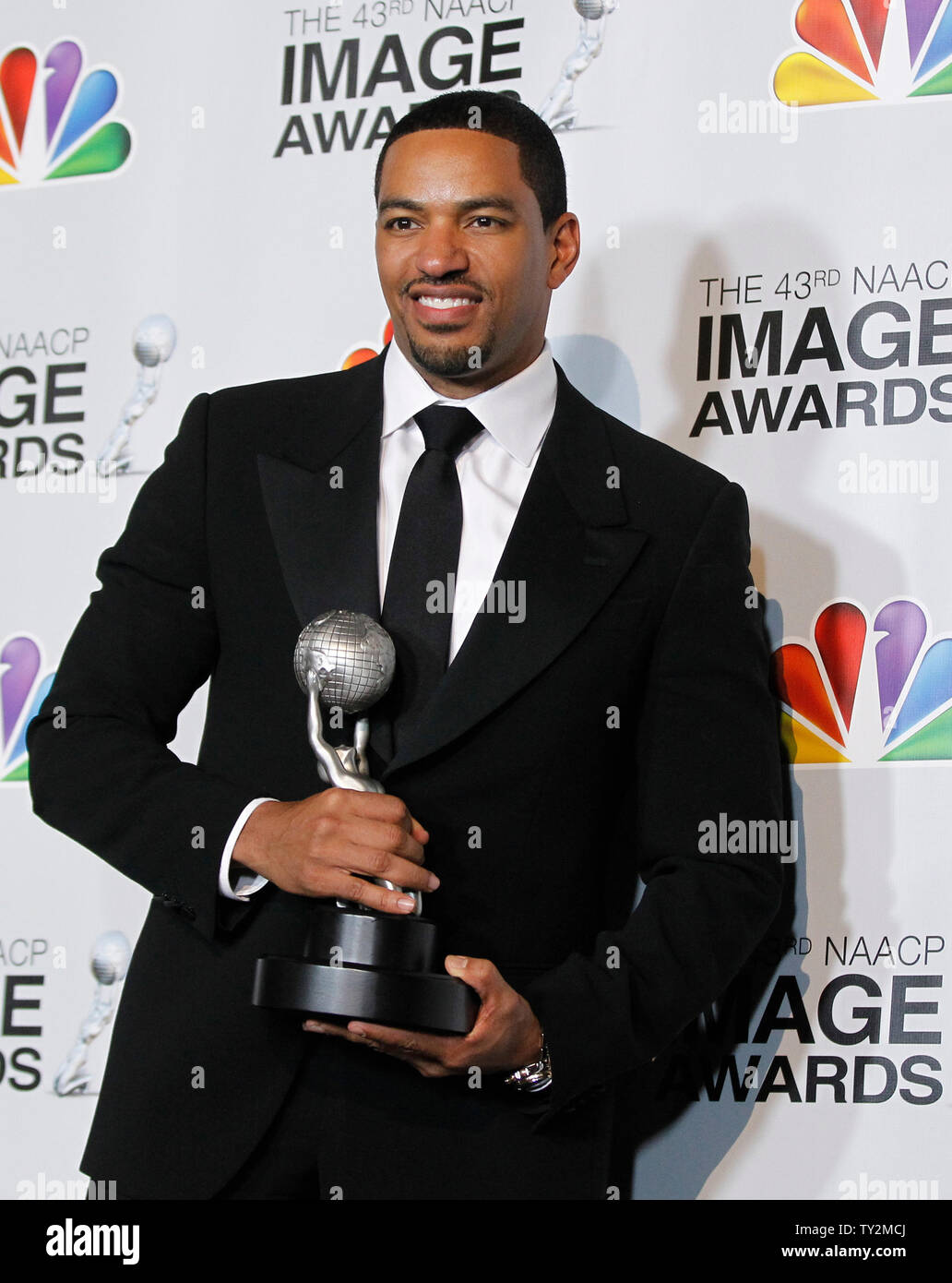 Actor Laz Alonzo holds his award for Outstanding Actor in a Motion ...