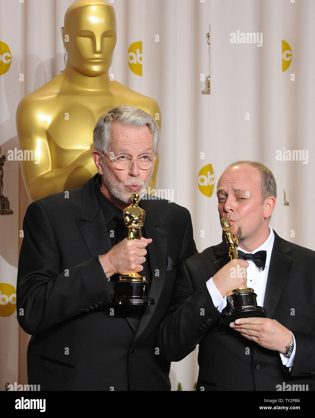 Mark Coulier and J. Roy Helland kiss their Oscars for Makeup while ...