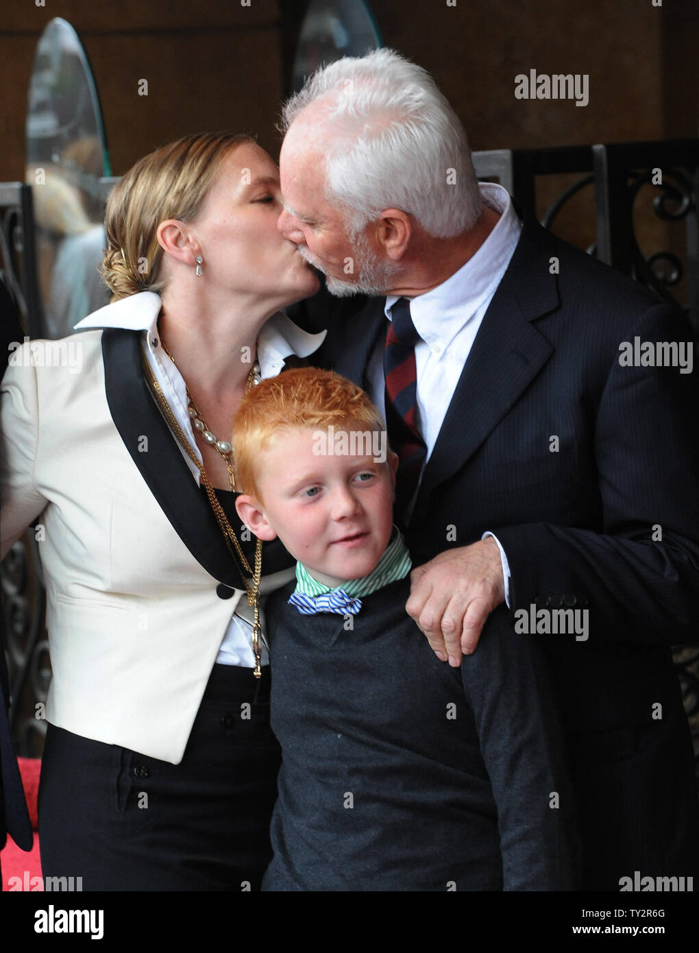 Actor Malcolm McDowell (R) kisses his wife Kelley as their son Beckett ...