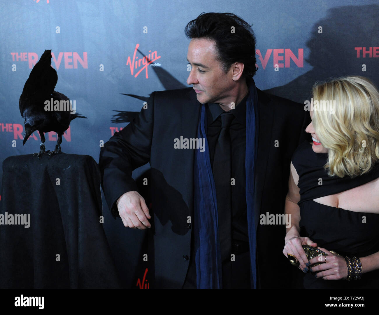 Actor John Cusack (L) and Alice Eve, cast members in the motion picture ...