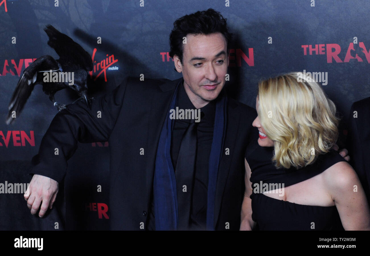 Actor John Cusack (L) and Alice Eve, cast members in the motion picture ...