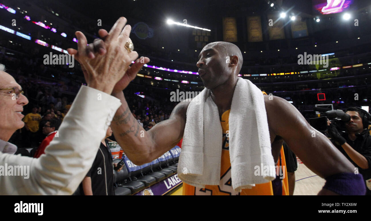 Los Angeles Lakers guard Kobe Bryant (R) high fives a fan after ...