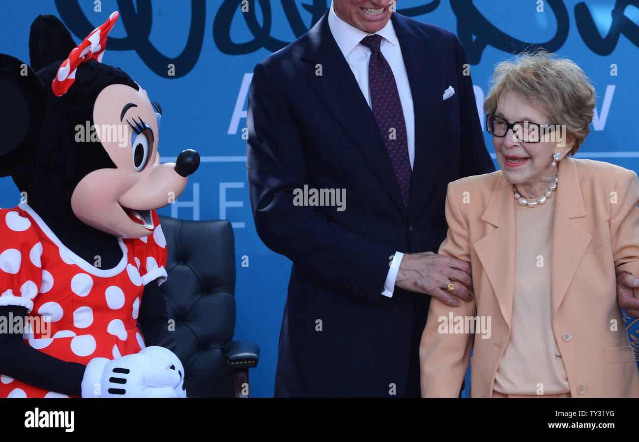 Former first lady Nancy Reagan (R) shares a moment with Minnie Mouse ...