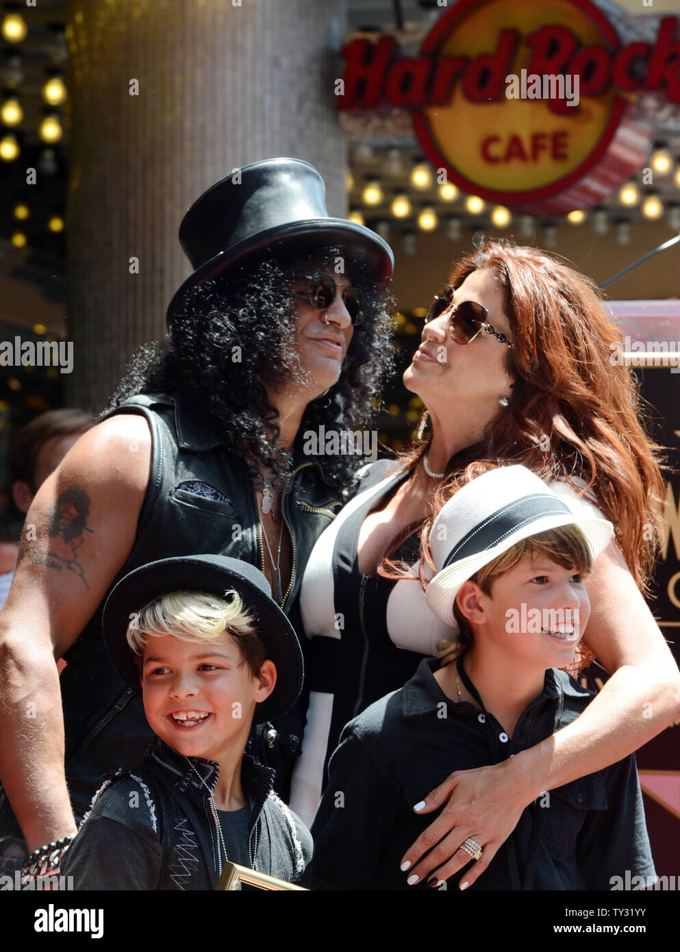 Musician Slash poses with his wife Peria Farrar and their sons Cash (L ...