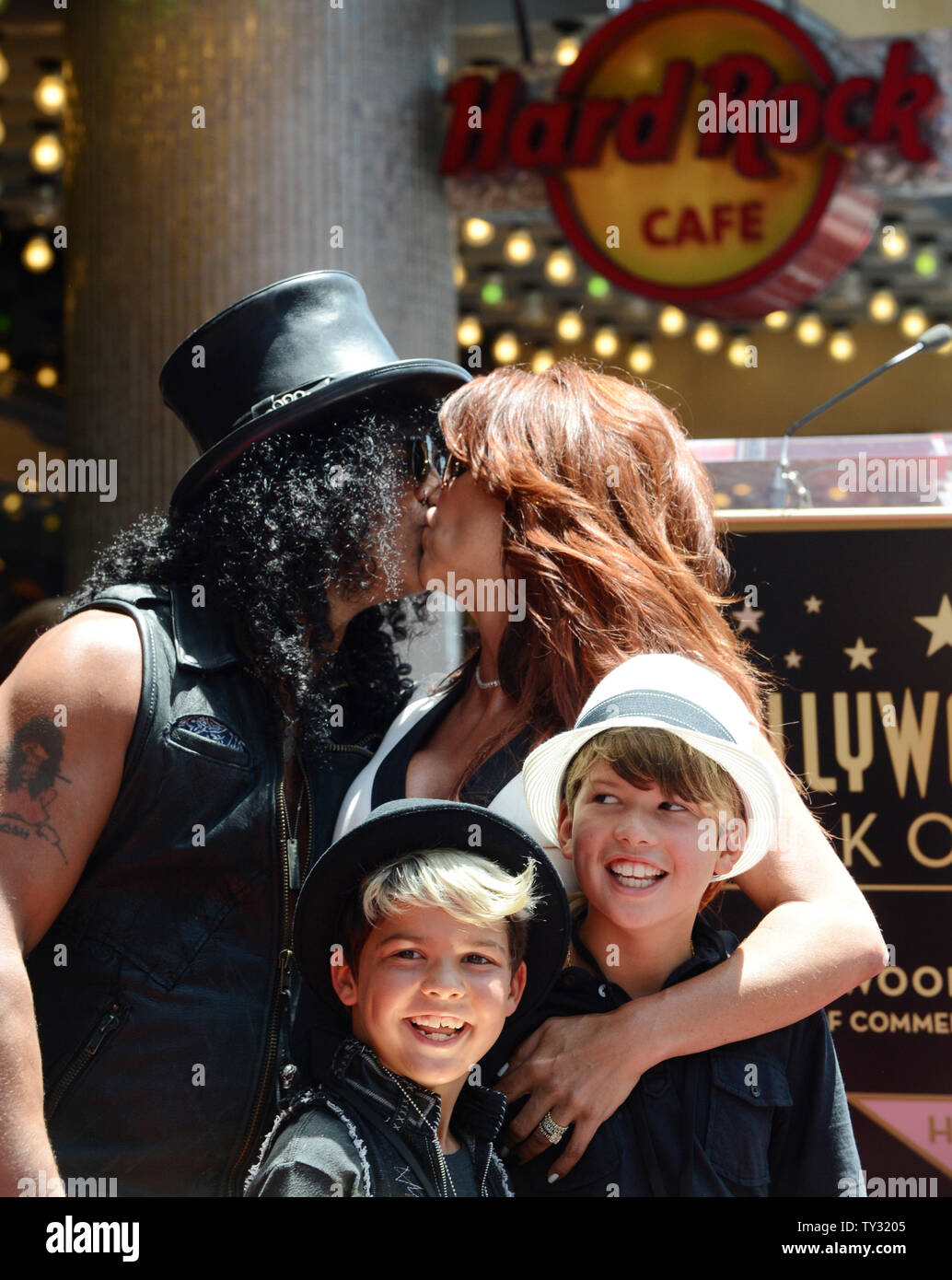 Musician Slash poses with his wife Peria Farrar and their sons Cash (L ...
