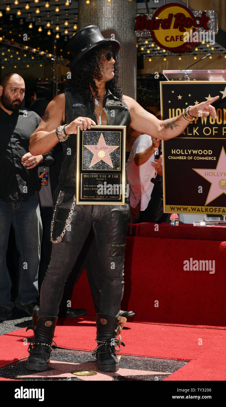 Musician Slash holds a replica plaque during an unveiling ceremony ...
