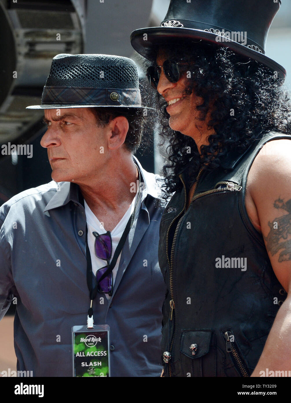 Musician Slash (R) reacts to comments by actor Charlie Sheen during an ...