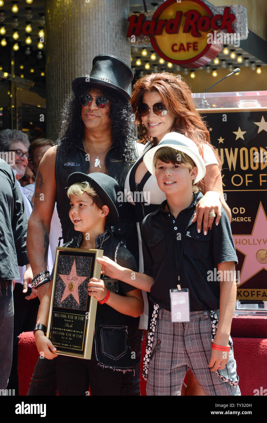 Musician Slash poses with his wife Peria Farrar and their sons Cash (L ...