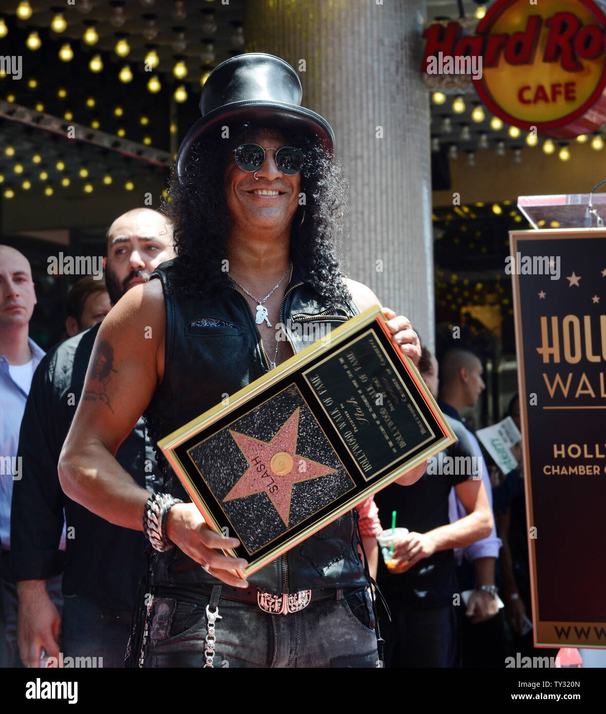Musician Slash holds a replica plaque during an unveiling ceremony ...