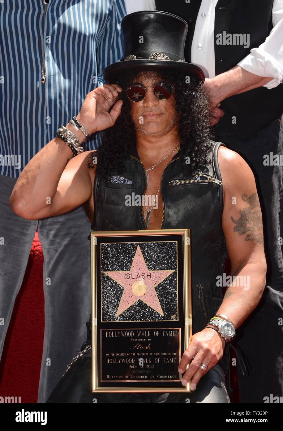 Musician Slash holds a replica plaque during an unveiling ceremony ...