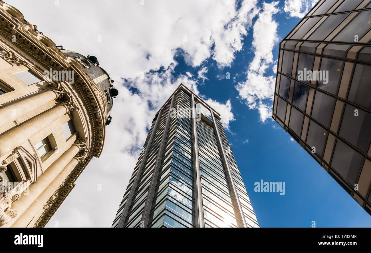 Shiny skyscraper surrounded by classic old architecture buildings Stock ...
