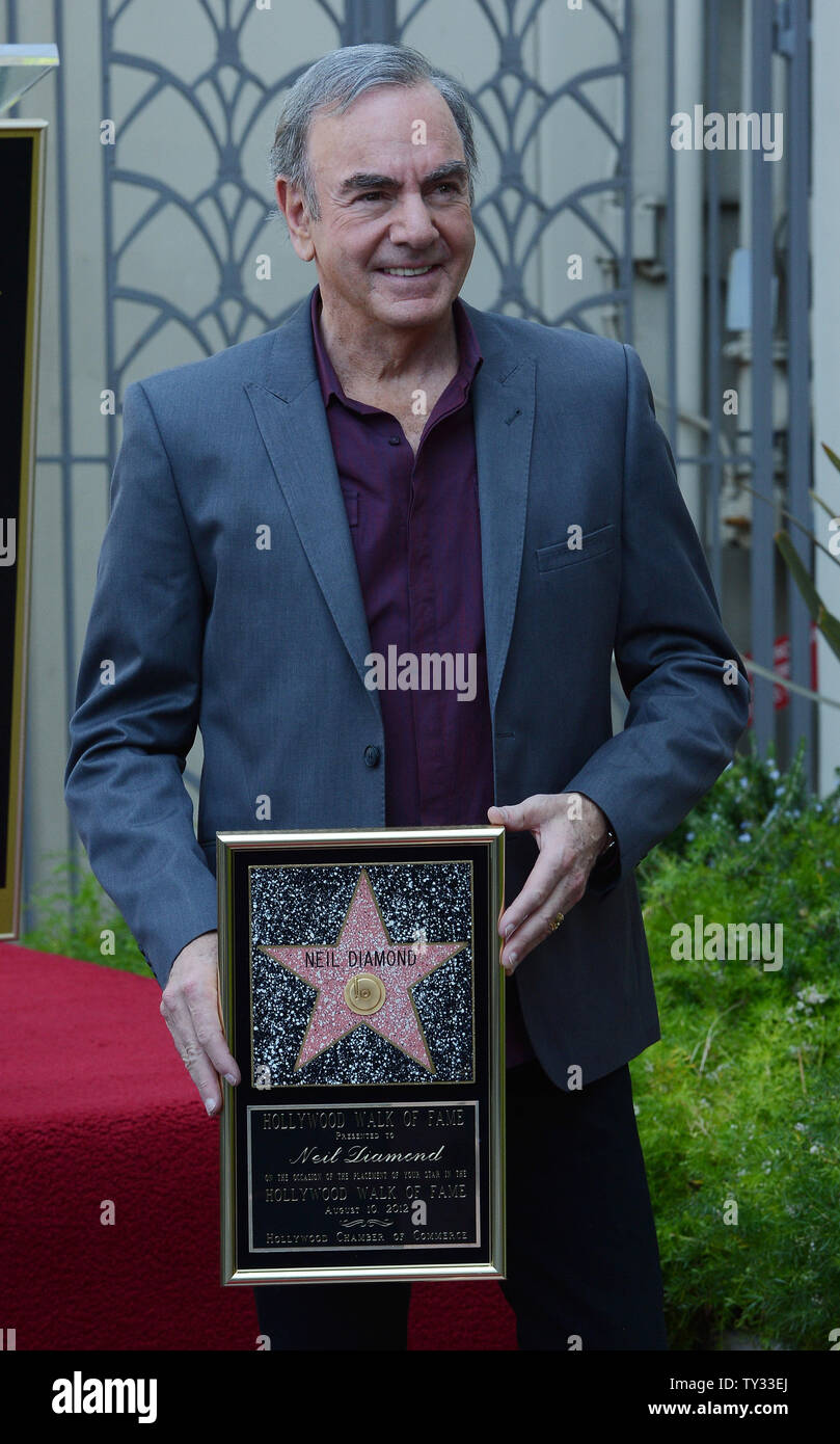 Singer and songwriter Neil Diamond holds a replica plaque during an ...