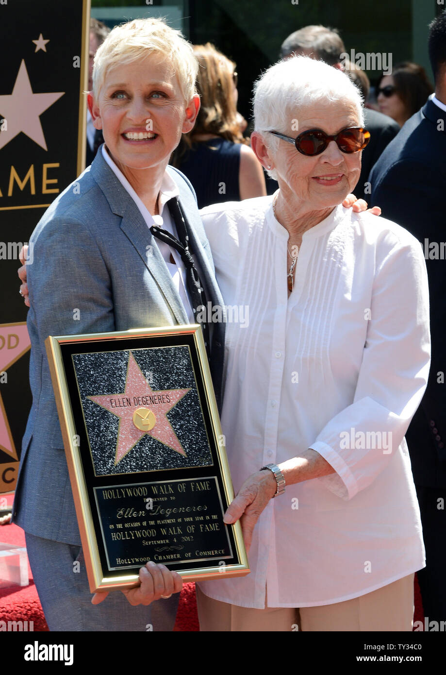 Television personality Ellen DeGeneres (L) holds a replica plaque as ...