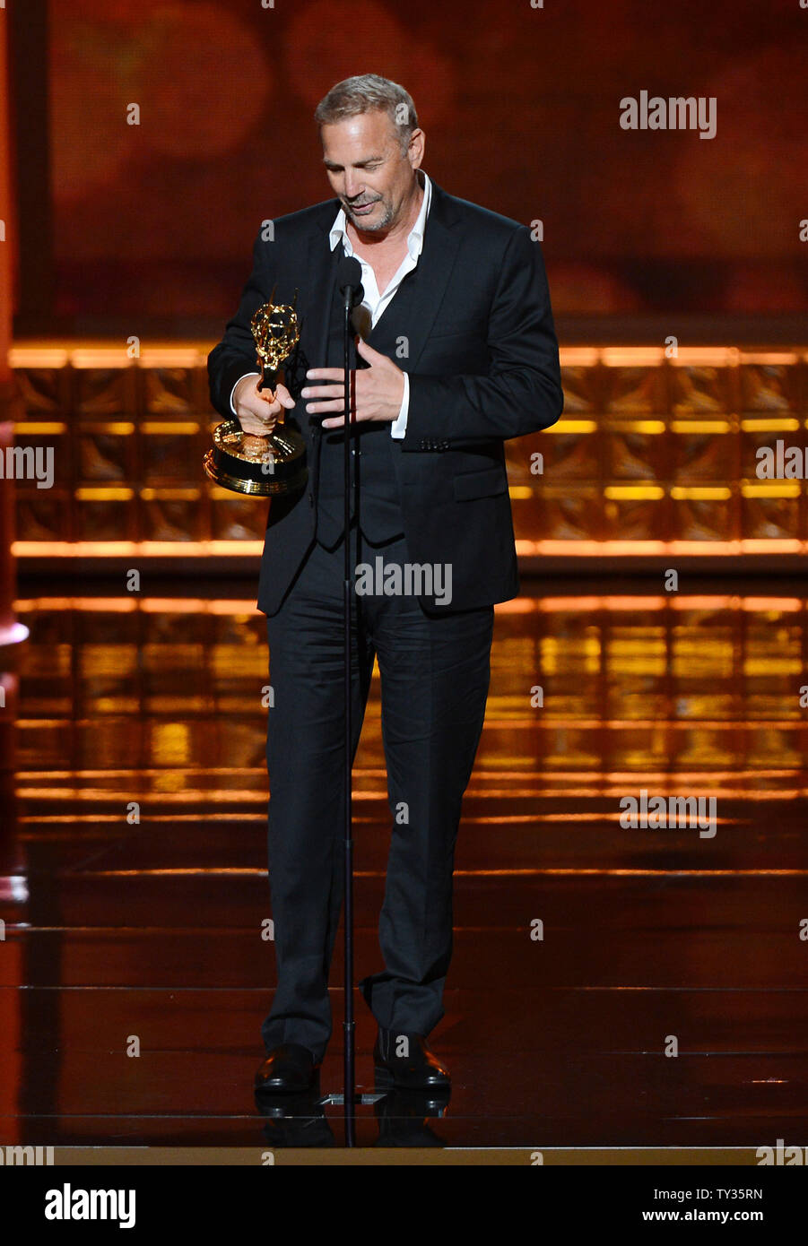 Actor Kevin Costner receives the Emmy Award for Outstanding Lead Actor ...